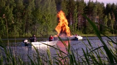 People in small boats watching a midrummer pyre in Finland … [139320623 ...